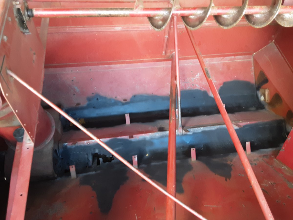 Installing grain tank liner in 1460, removing auger cover supports ...