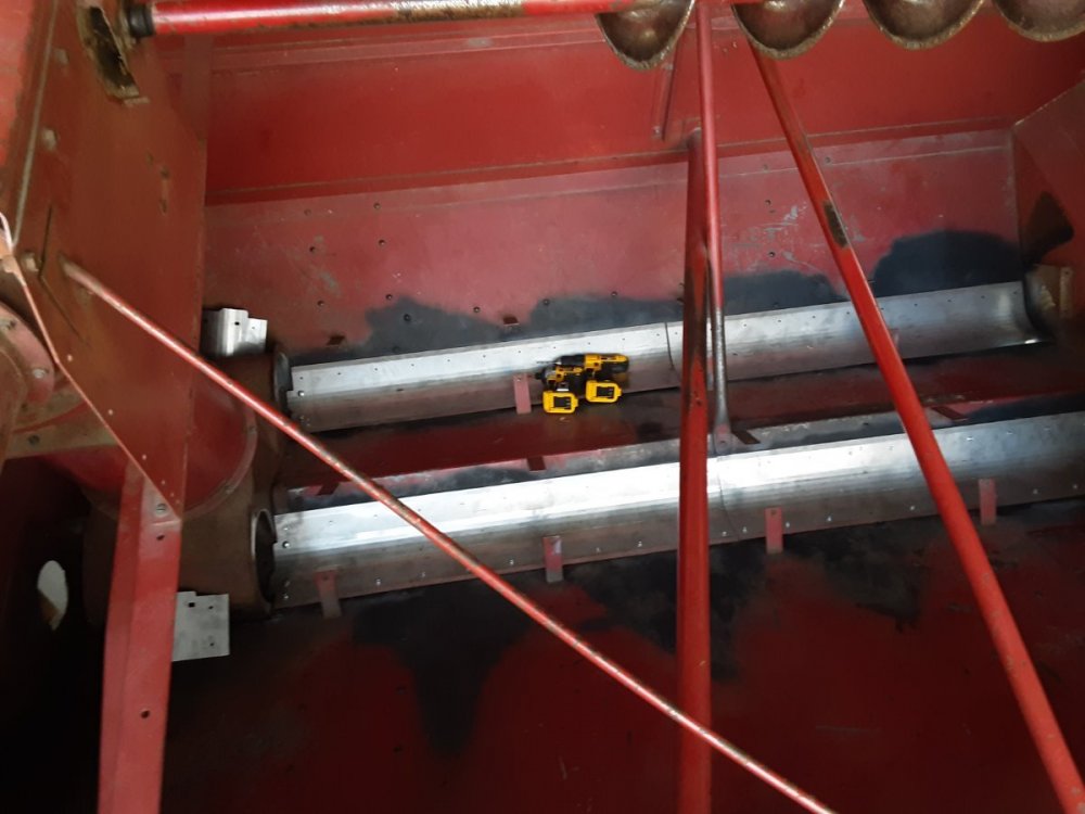 Installing grain tank liner in 1460, removing auger cover supports ...